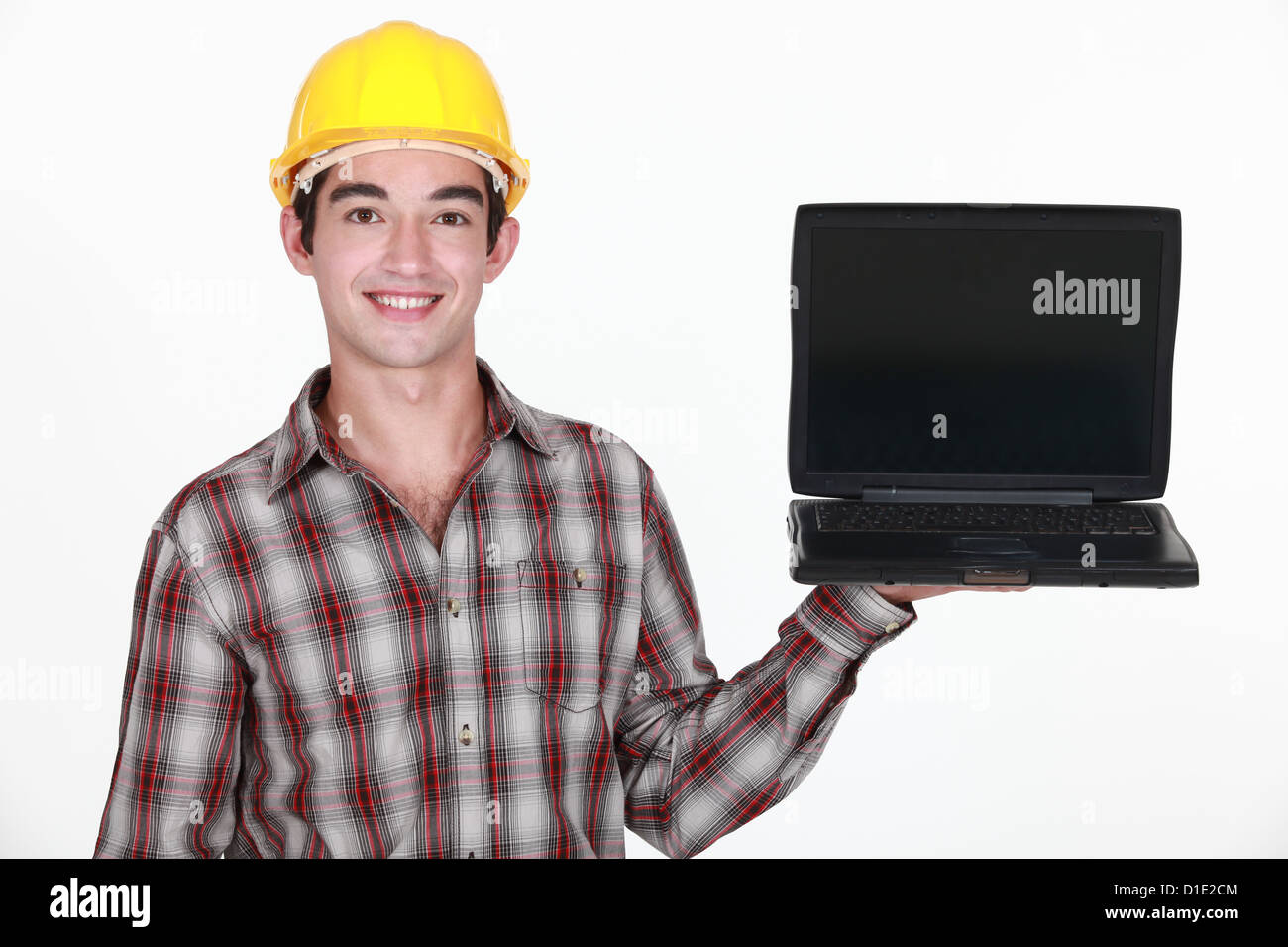 Young laborer holding laptop Stock Photo - Alamy