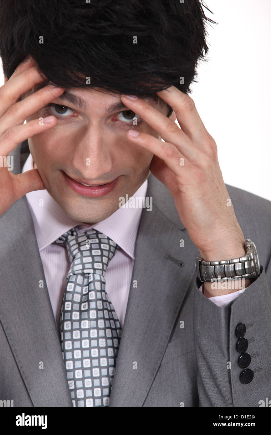 businessman with hands to forehead facing pressure Stock Photo - Alamy