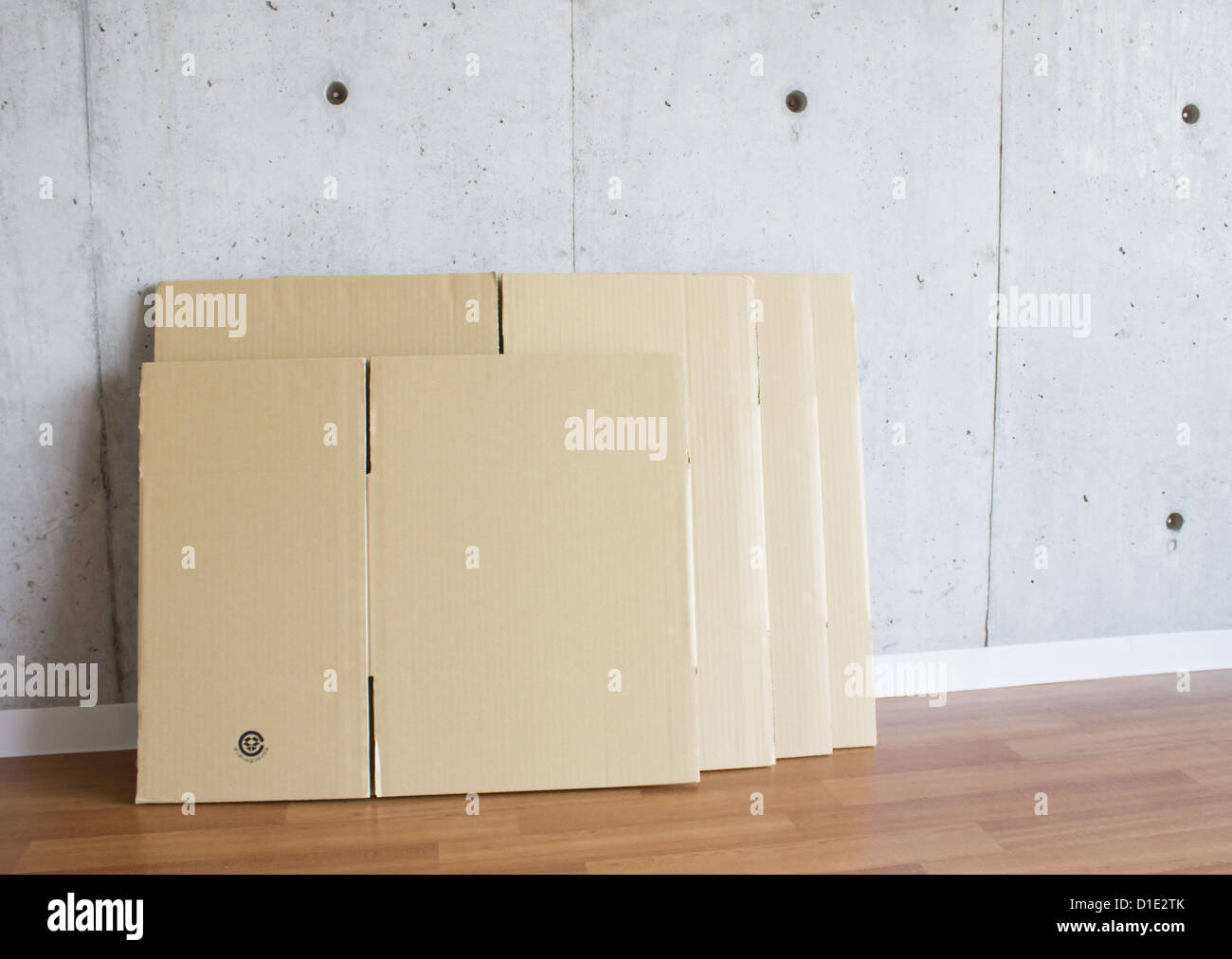 Concrete wall and cardboard boxes Stock Photo - Alamy