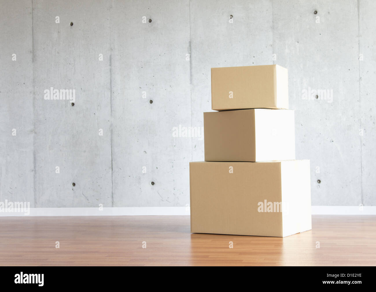 Concrete wall and cardboard boxes Stock Photo - Alamy