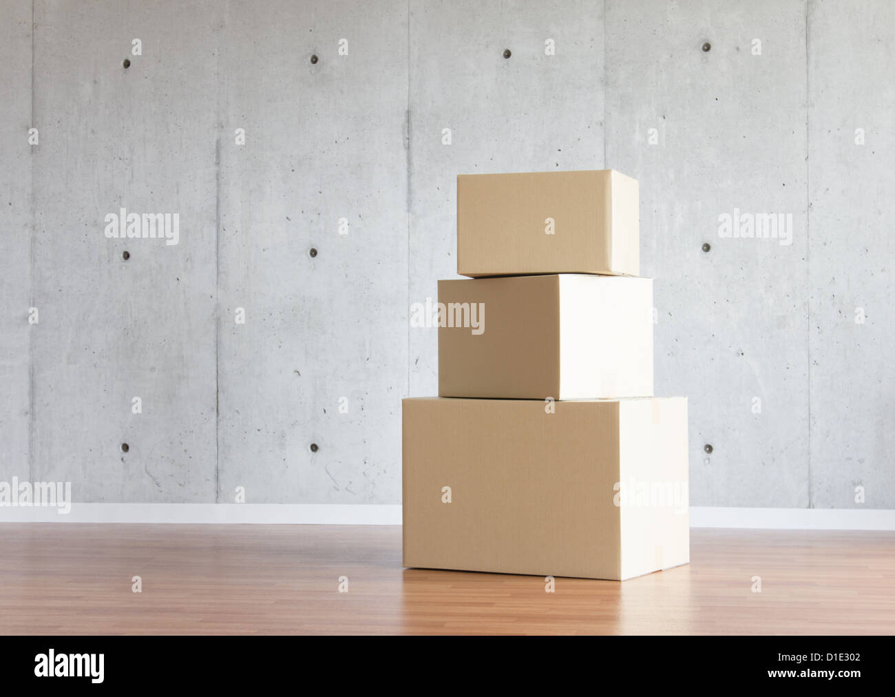 Concrete wall and cardboard boxes Stock Photo - Alamy