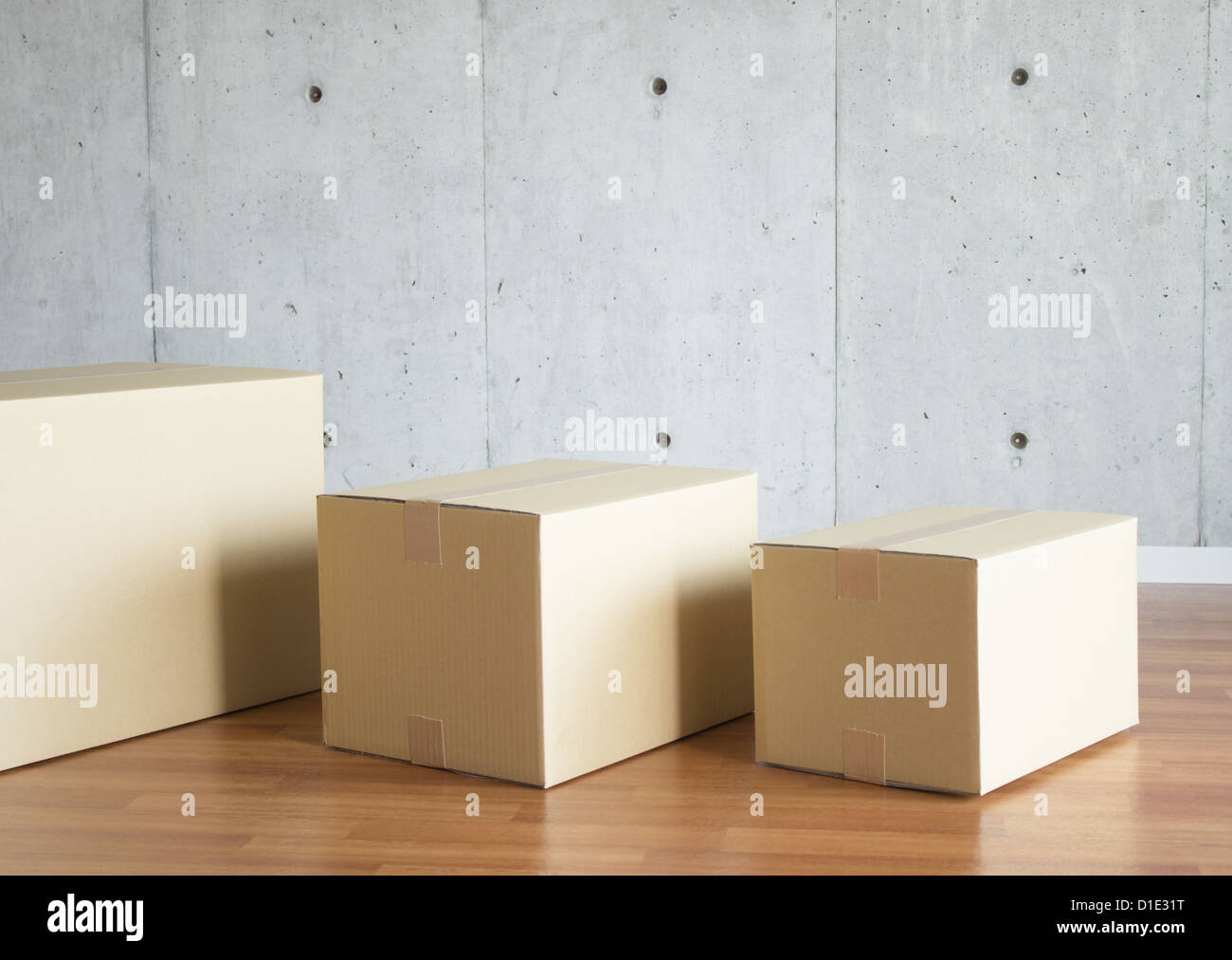 Concrete wall and cardboard boxes Stock Photo - Alamy