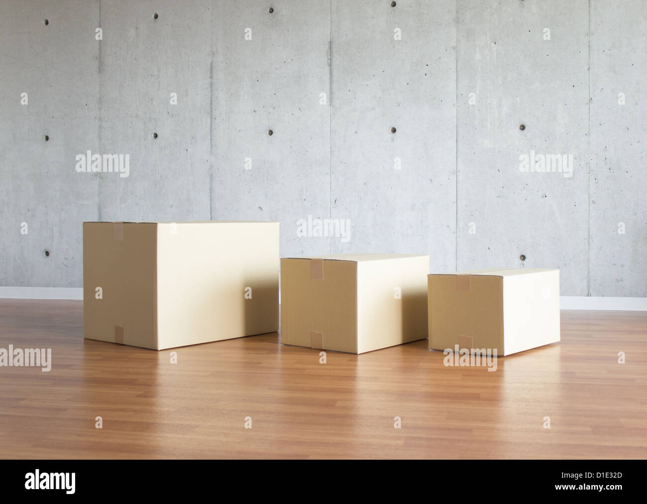 Concrete wall and cardboard boxes Stock Photo - Alamy
