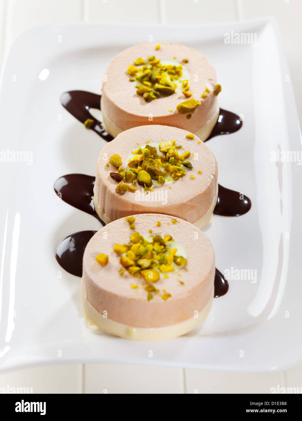 Delicious small cream cakes with pistachio Stock Photo - Alamy