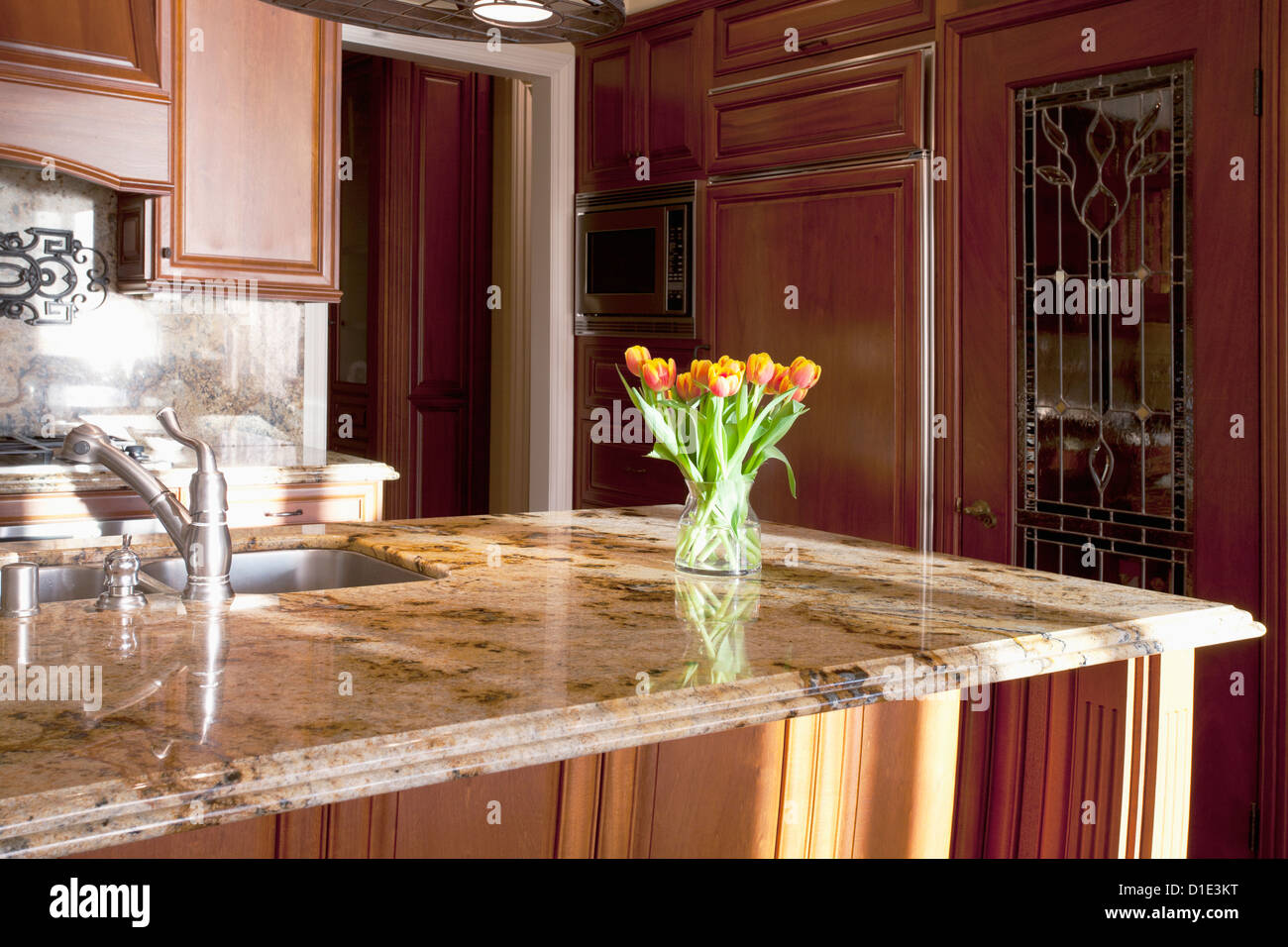 Vase of tulips on kitchen countertop; Laguna Beach; California; USA ...