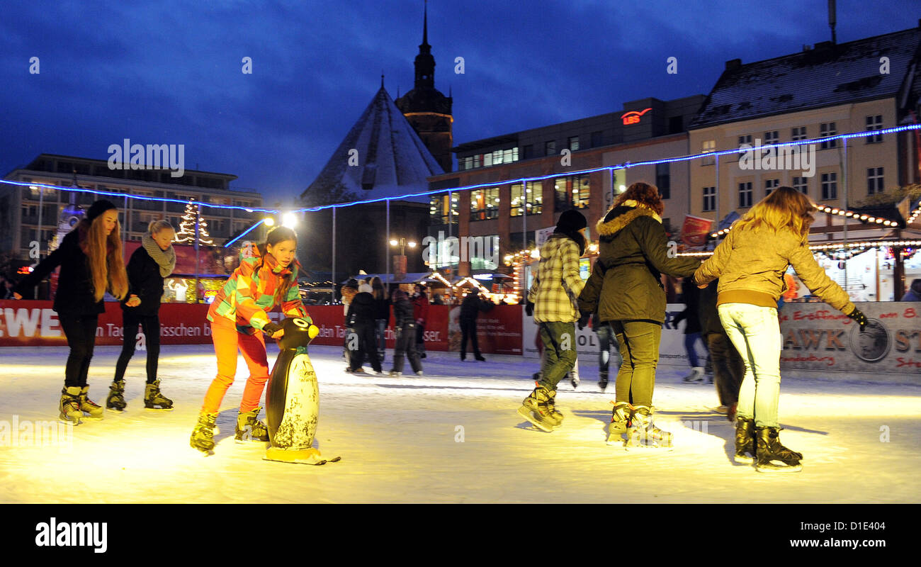 People are pictured practicing ice skating with the plastic penguin aid ...