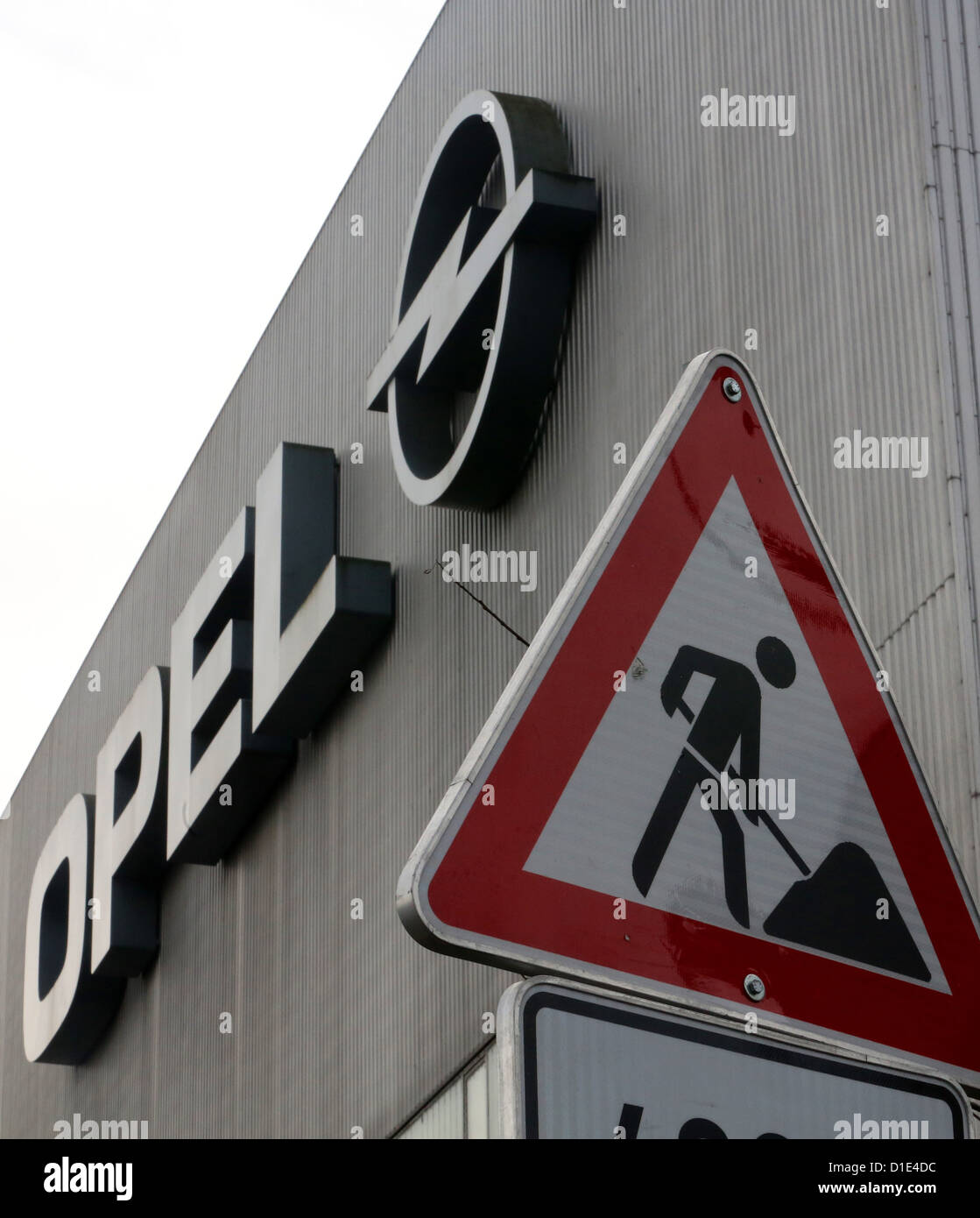 A construction site sign stands at a construction site in front of the ...