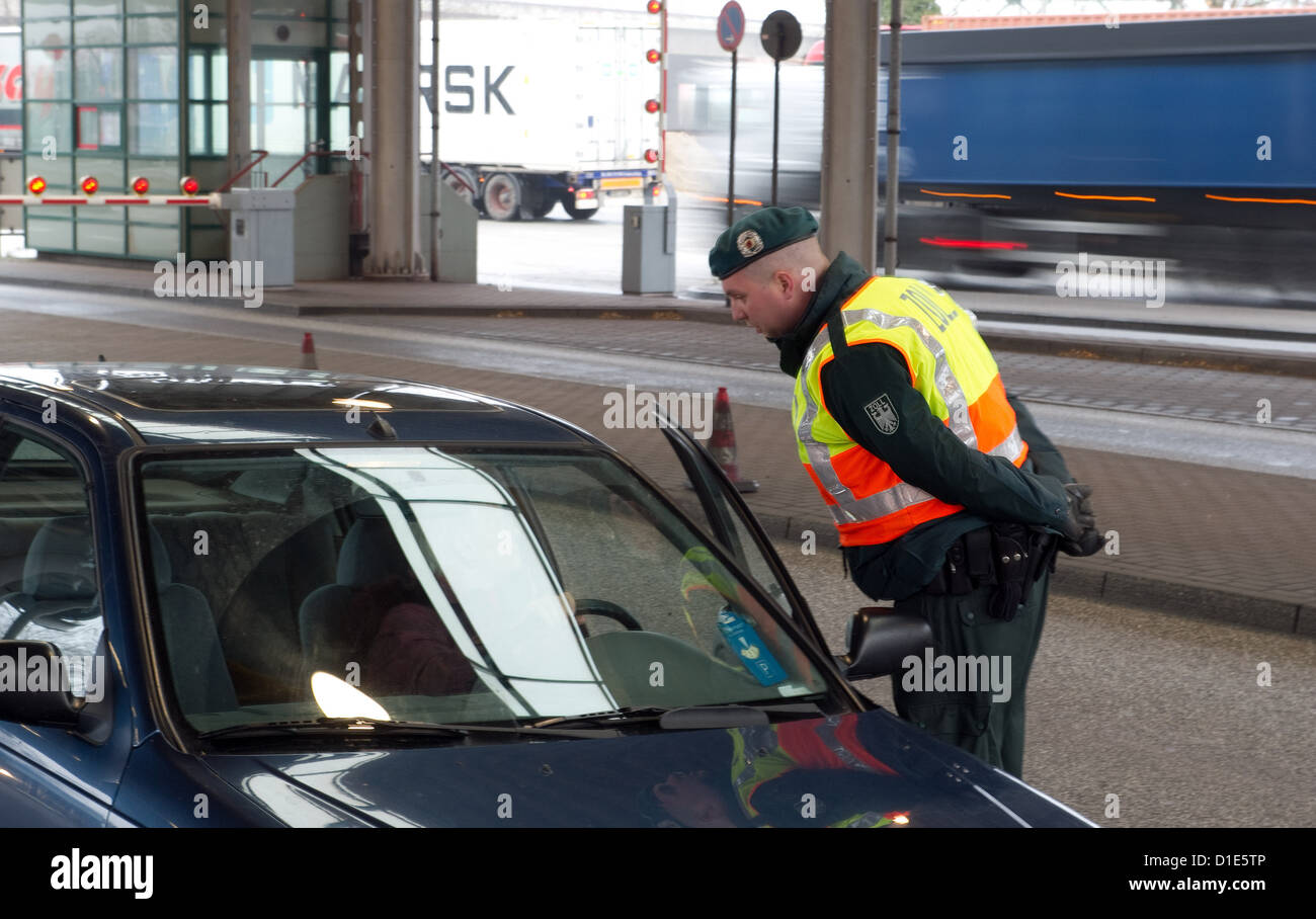 Customs officers check the freight of trucks at the Free Harbour border ...