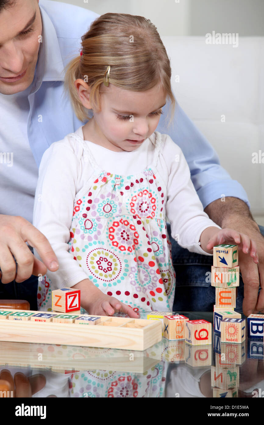 Father and daughter playing with building blocks Stock Photo - Alamy