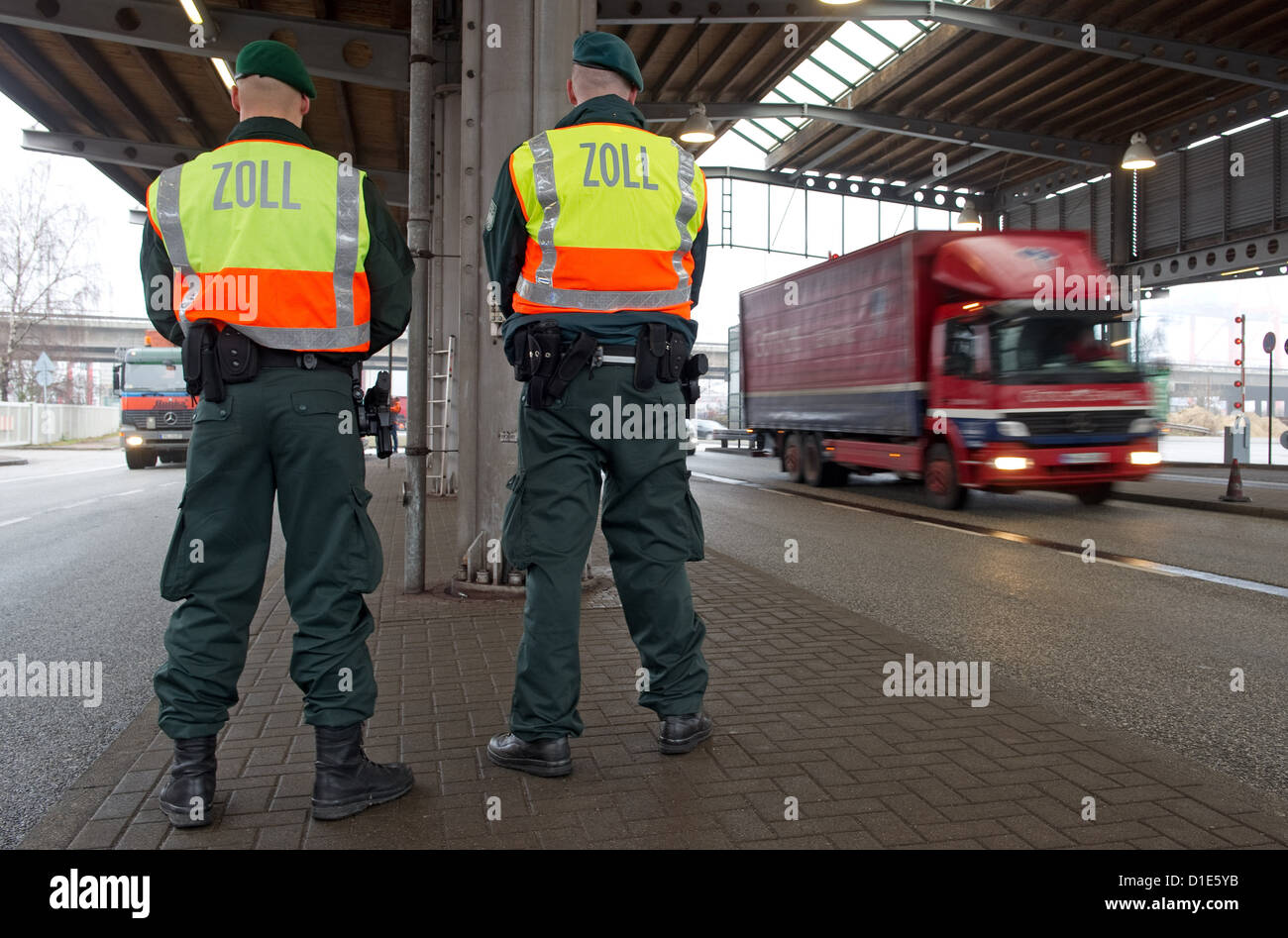 Customs officers check the freight of trucks at the Free Harbour border ...