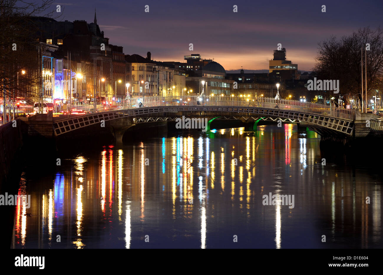 Lights reflect in the Liffey river under the Half Penny Bridge in ...