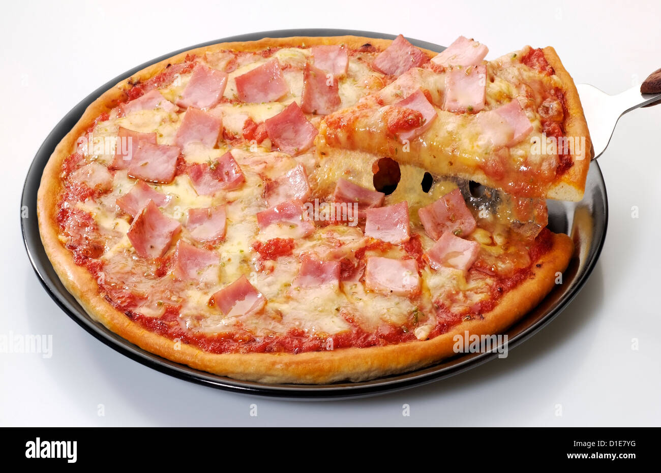 Ham pizza and slice Stock Photo - Alamy