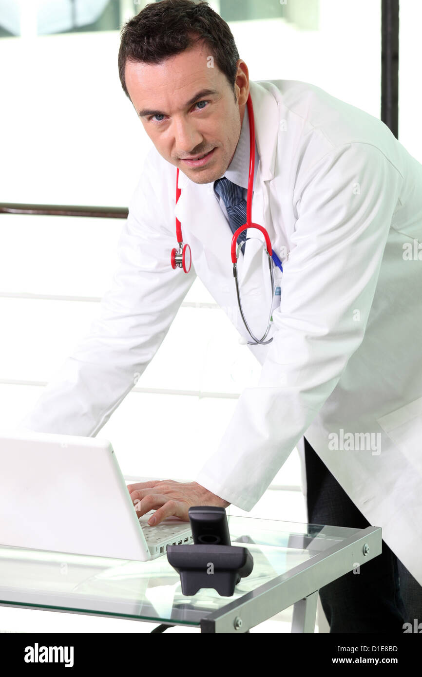 Doctor looking at computer Stock Photo - Alamy