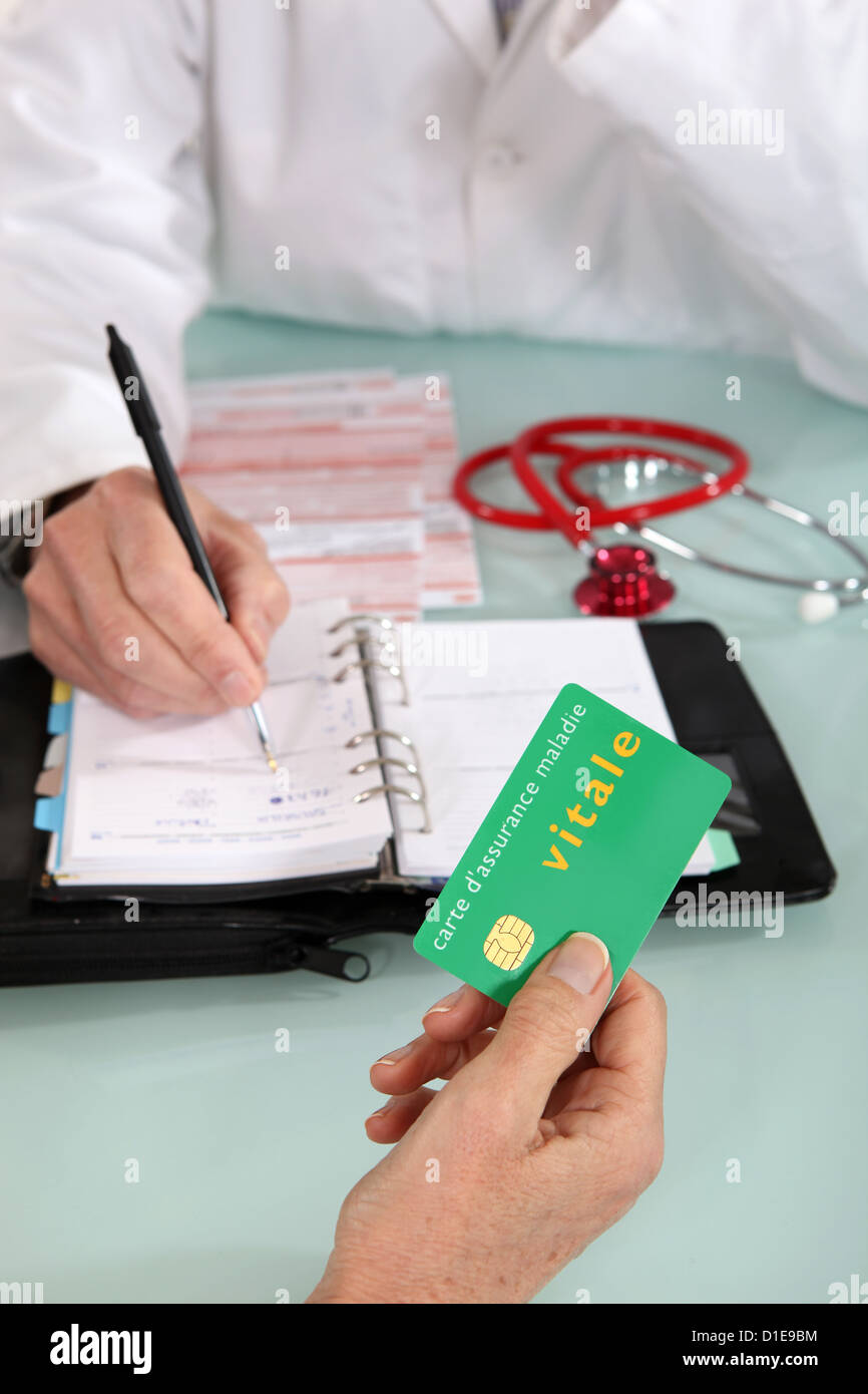 Patient handing social security card to doctor Stock Photo - Alamy