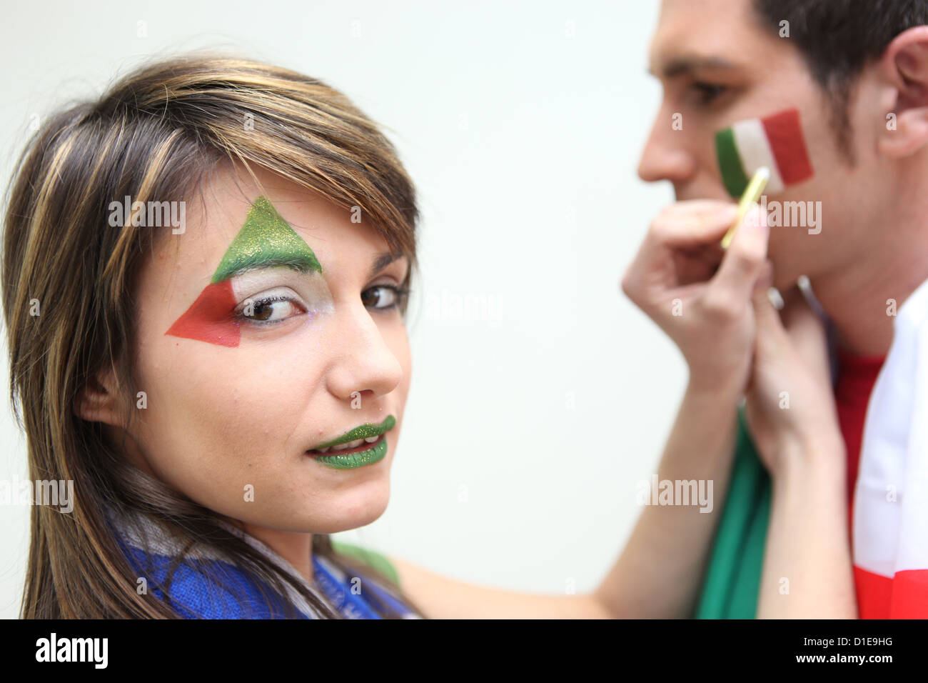 Italian football fans putting on facepaint Stock Photo - Alamy