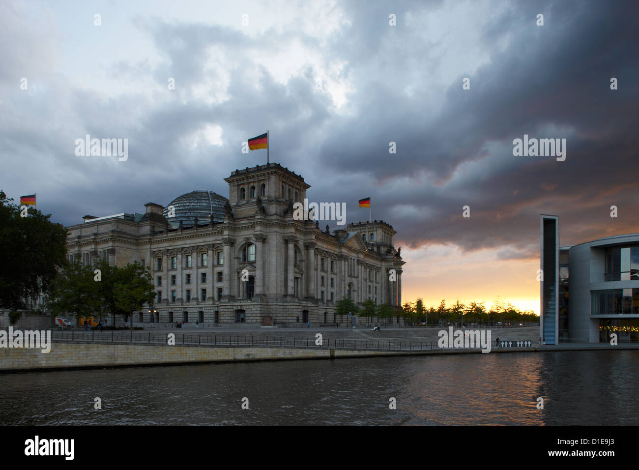 Berlin, Germany, the Reichstag and the river under dark cloudy sky ...