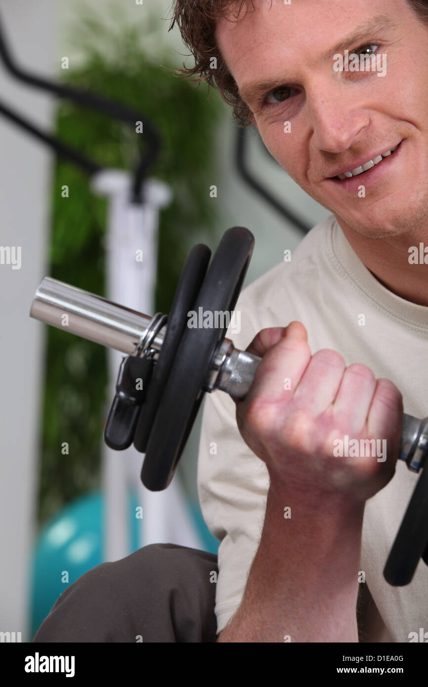 Man lifting a dumbbell Stock Photo - Alamy