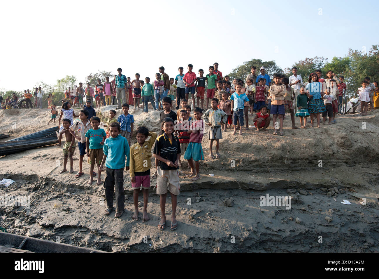 Villagers waiting on the riverbank of the River Hugli to welcome ...