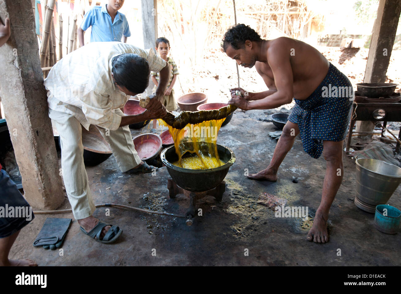 Two men squeezing yellow dye hi-res stock photography and images - Alamy