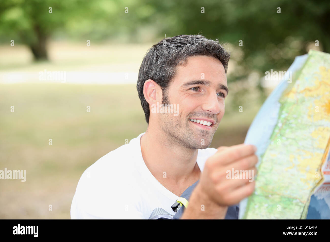 Man looking at map Stock Photo - Alamy