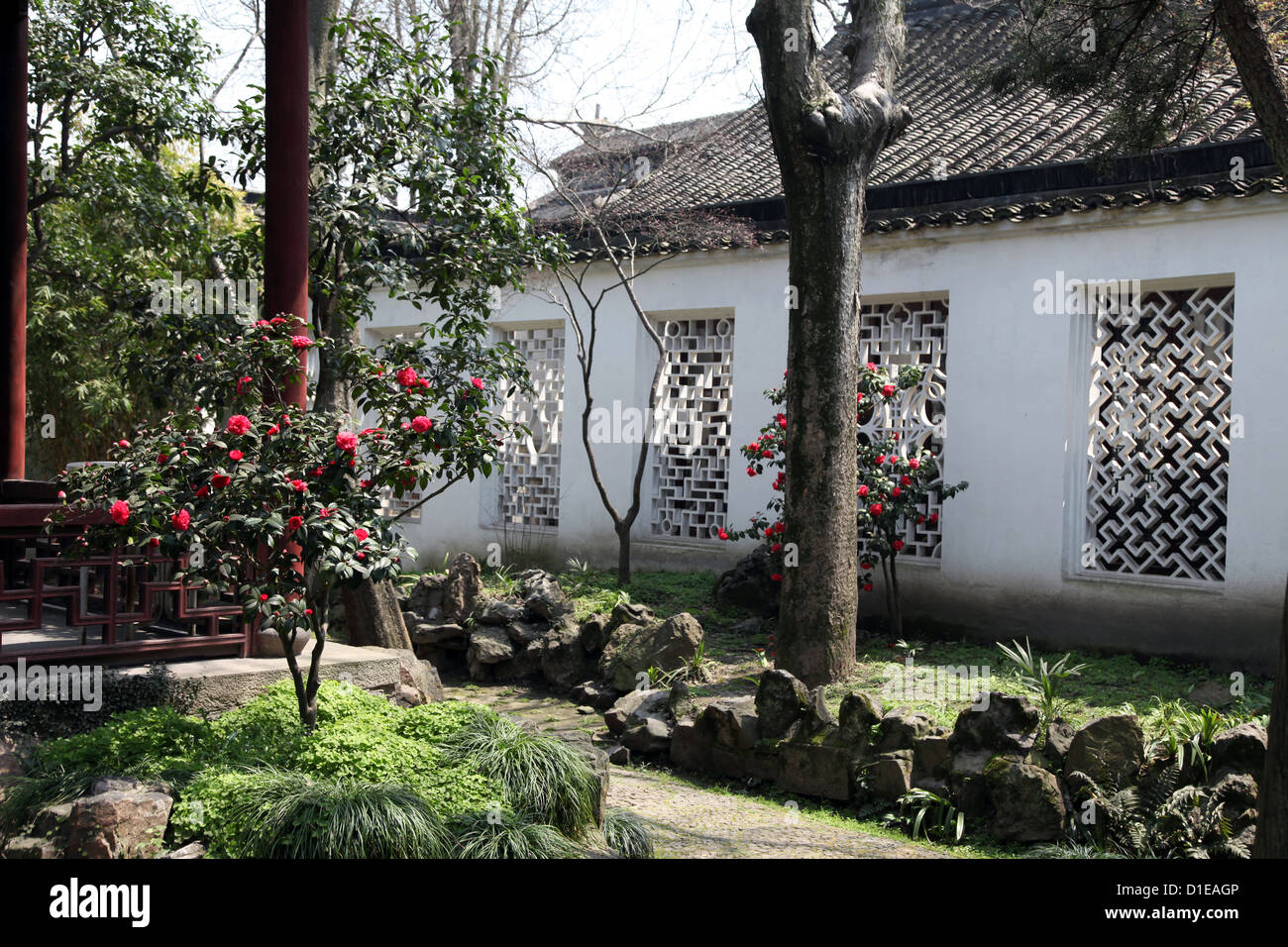 It's a photo of a garden inside a courtyard of a Chinese temple. It ...