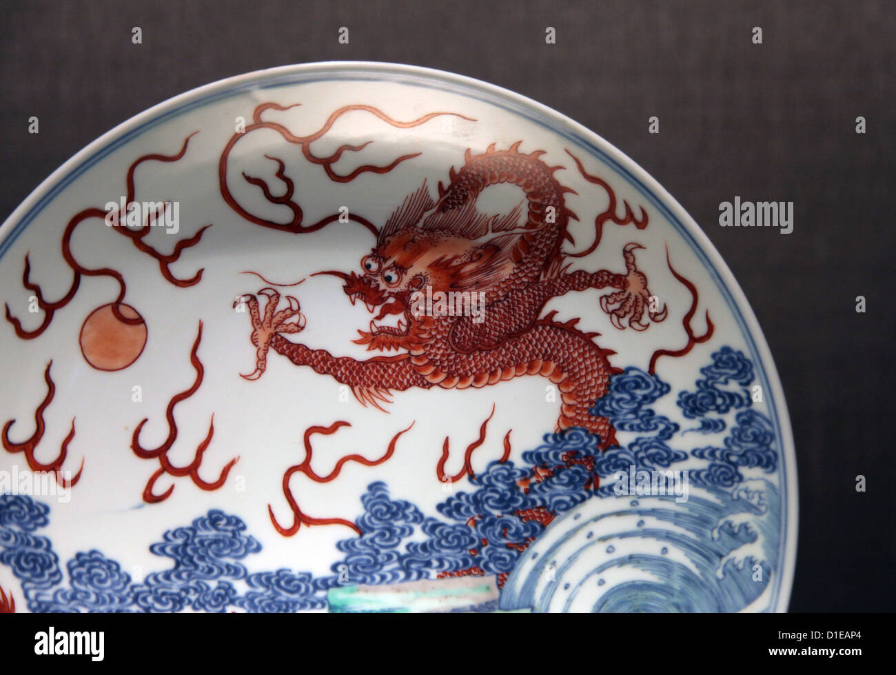 It's a photo of a Chinese red dragon that is painted on a Chinese plate ...