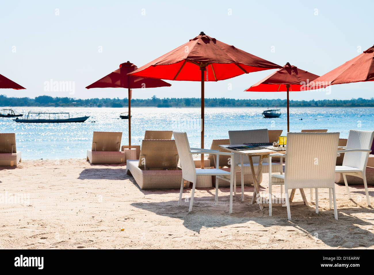 Cafe on a tropical beach with blue sea on background Stock Photo - Alamy