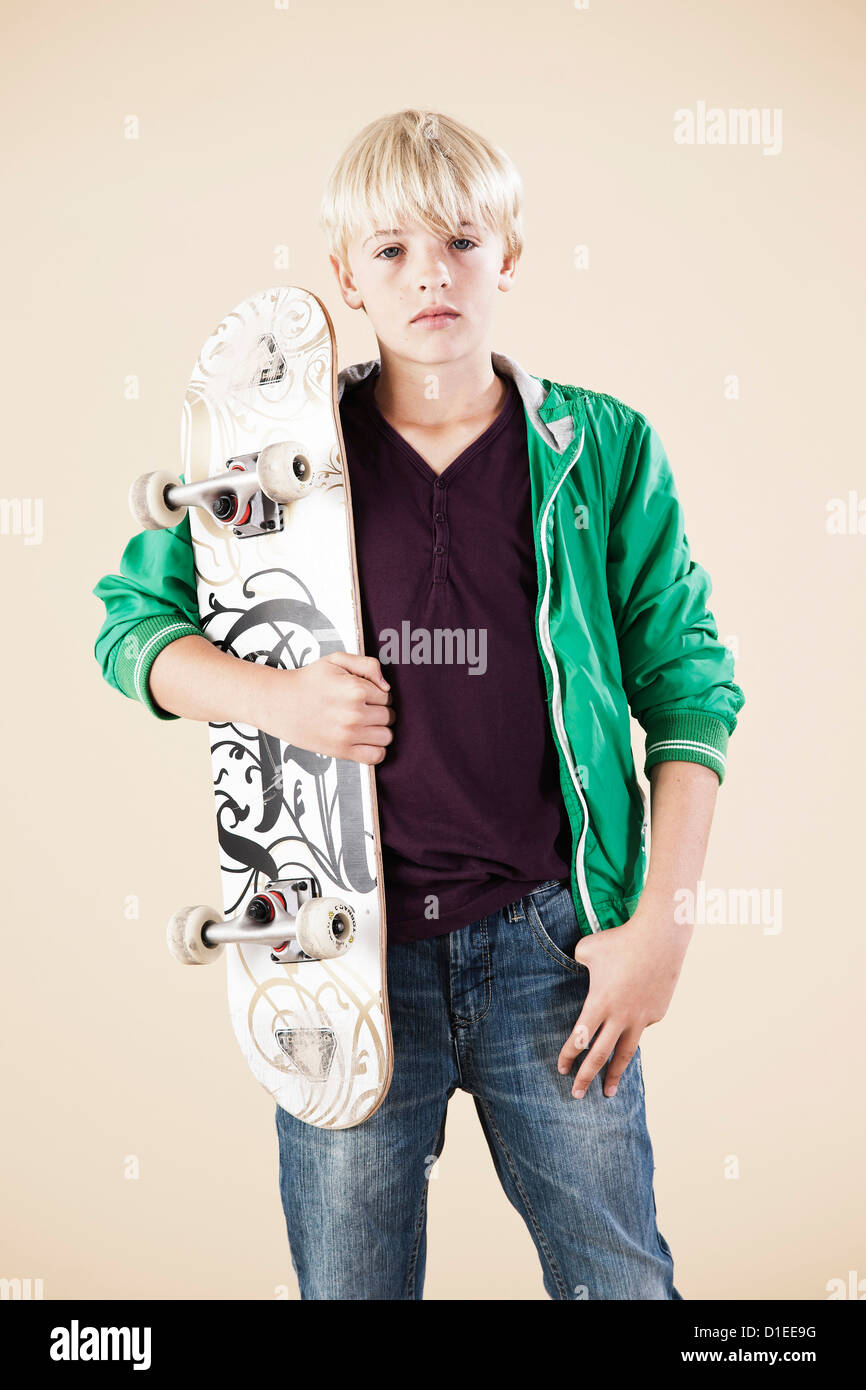 Blond boy with skateboard Stock Photo - Alamy