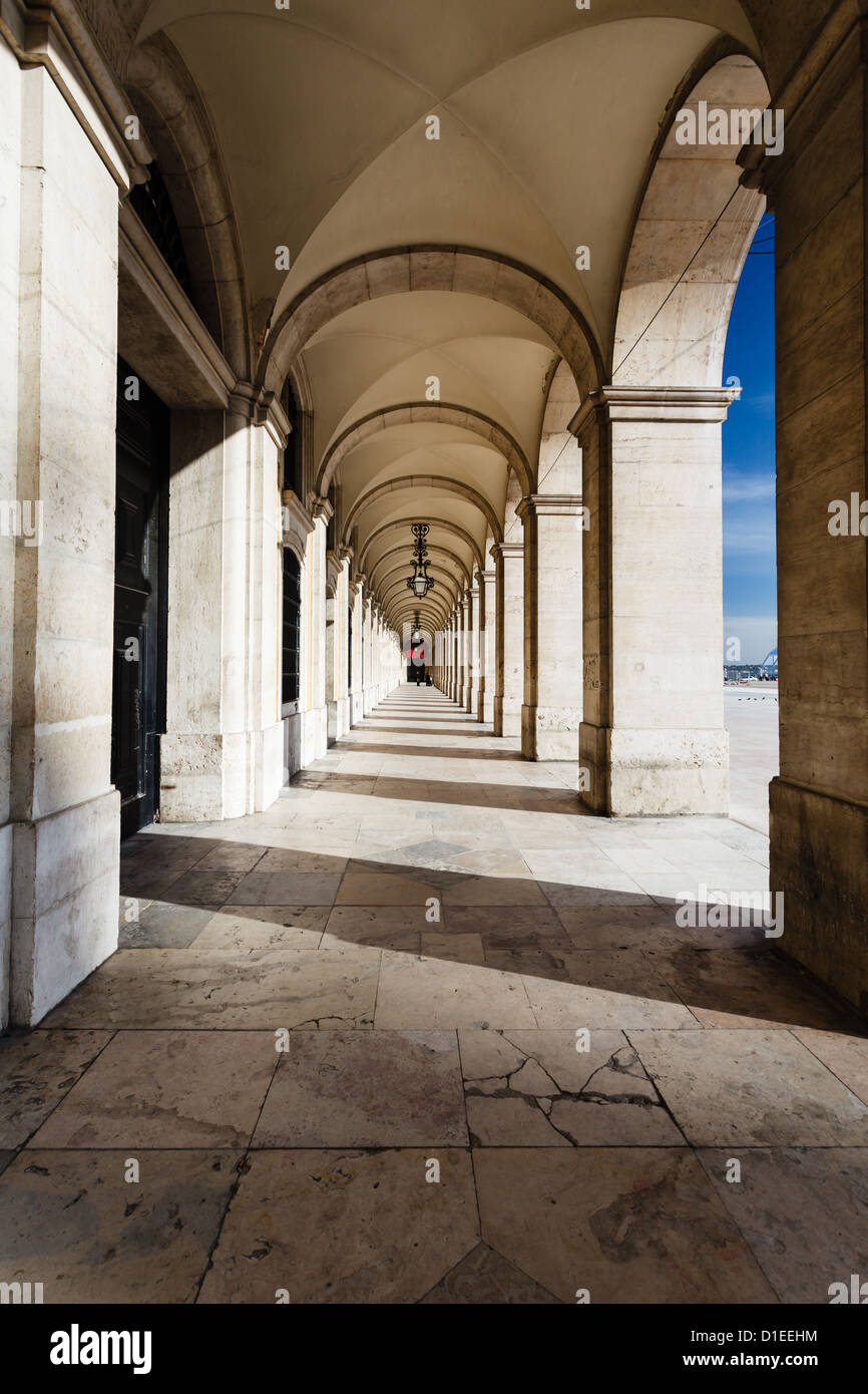 Sunlight, shadows in long marble covered corridor with vaulted ceiling ...