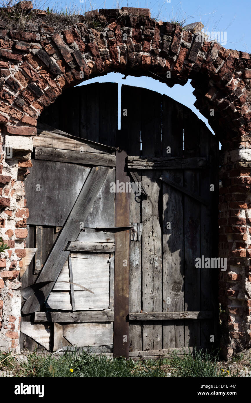 Old closed wooden door on ruin brick wall Stock Photo - Alamy