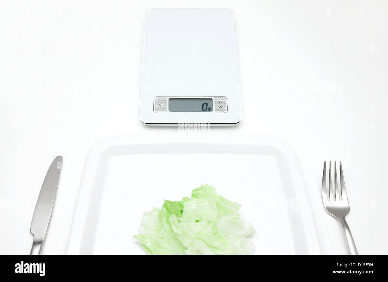 Plate with salad and scales Stock Photo - Alamy