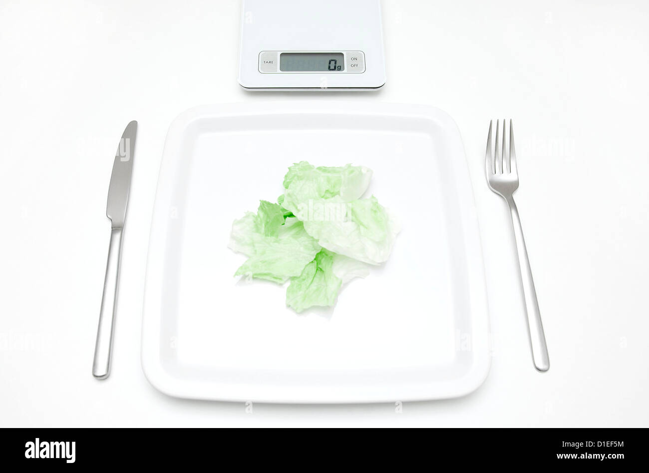 Plate with salad and scales Stock Photo - Alamy