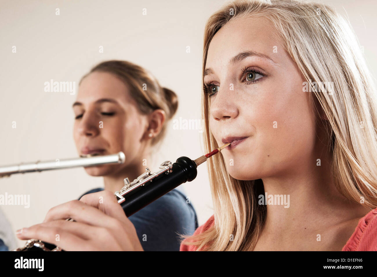 Two teenage girls playing oboe and transverse flute Stock Photo - Alamy