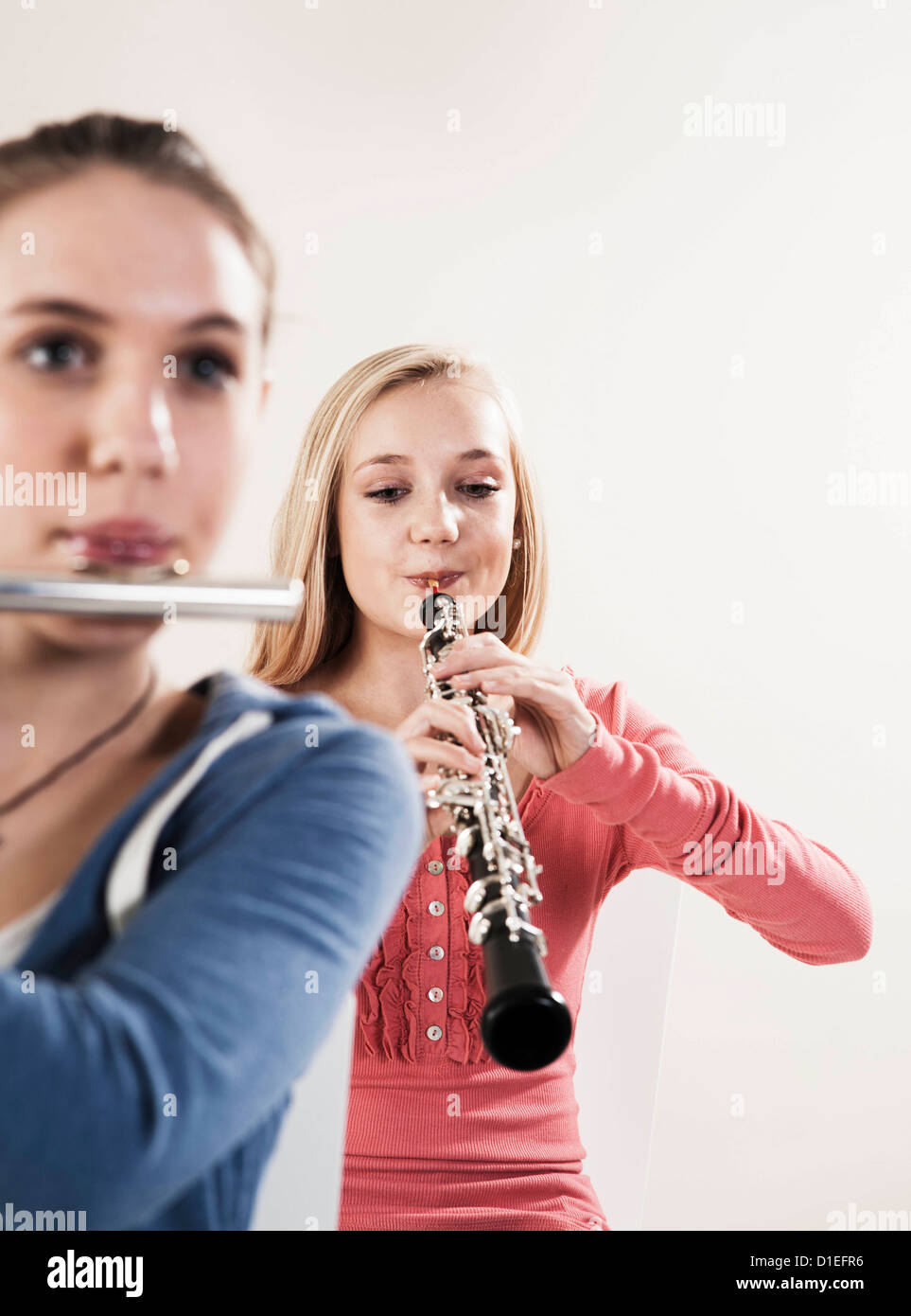 Two teenage girls playing oboe and transverse flute Stock Photo - Alamy