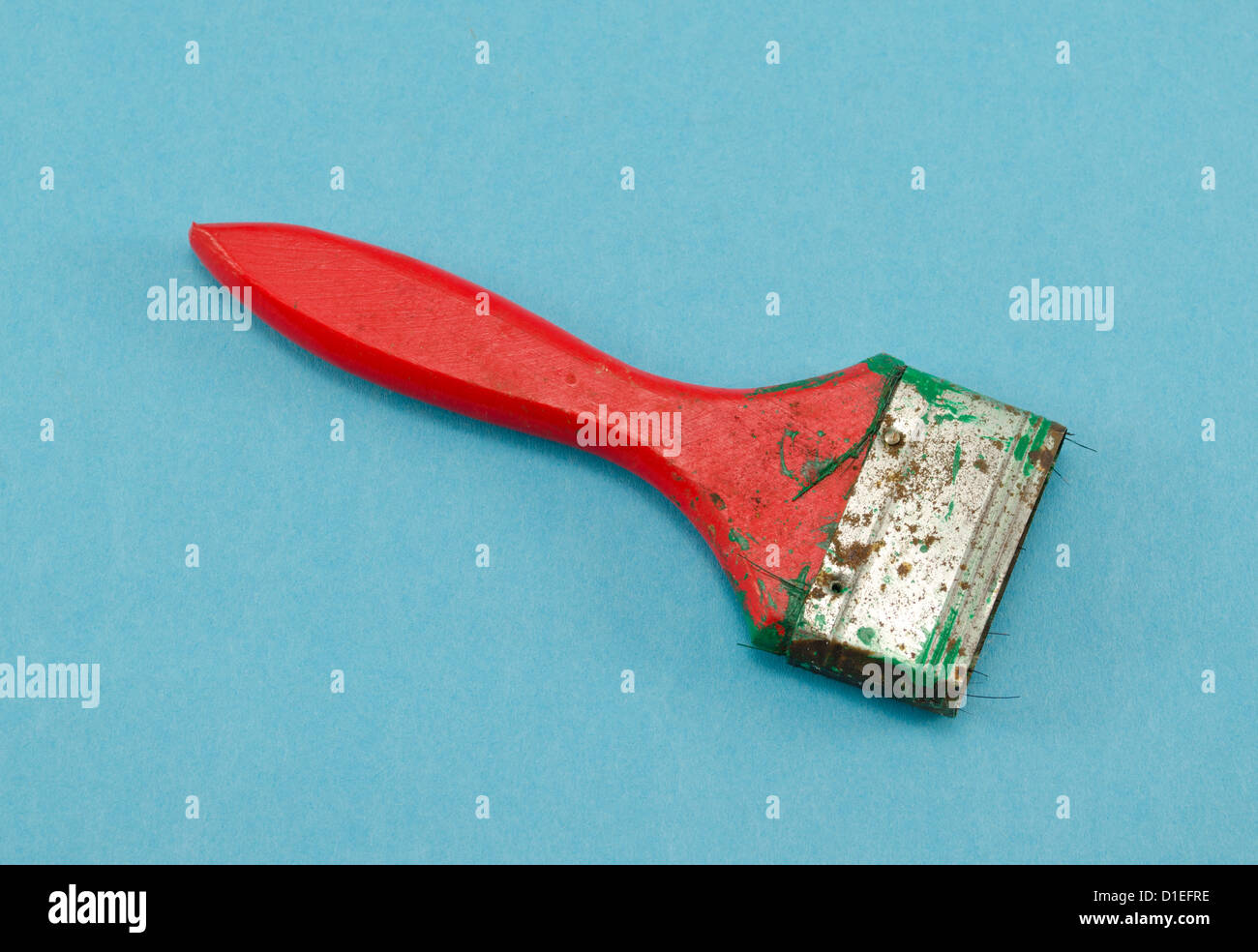 red broken paint brush tool handle on blue background Stock Photo - Alamy