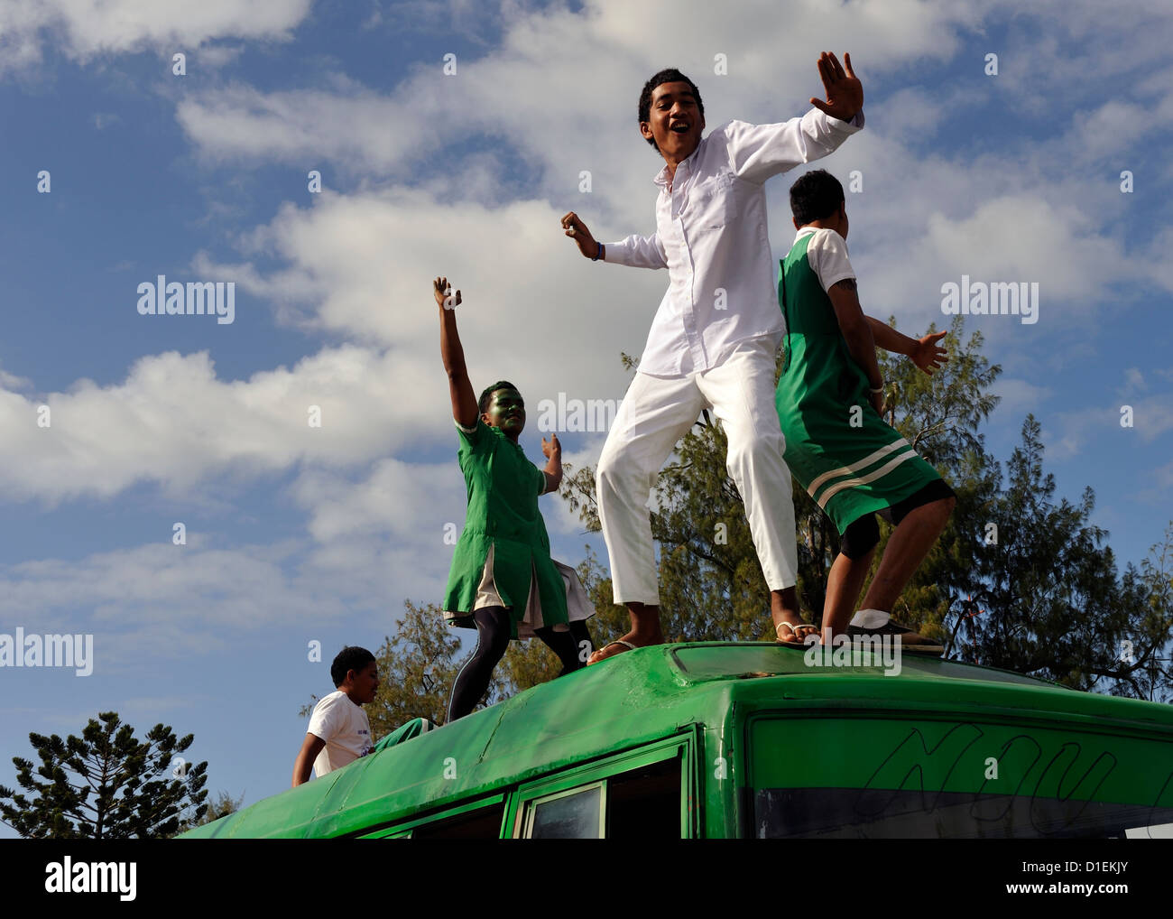 Children dancing on roof of school bus, part of the Float Parade for ...