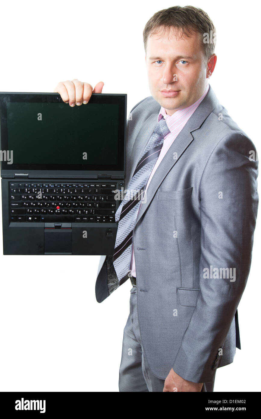 successful business man in a stylish suit keeps laptop on an isolated ...