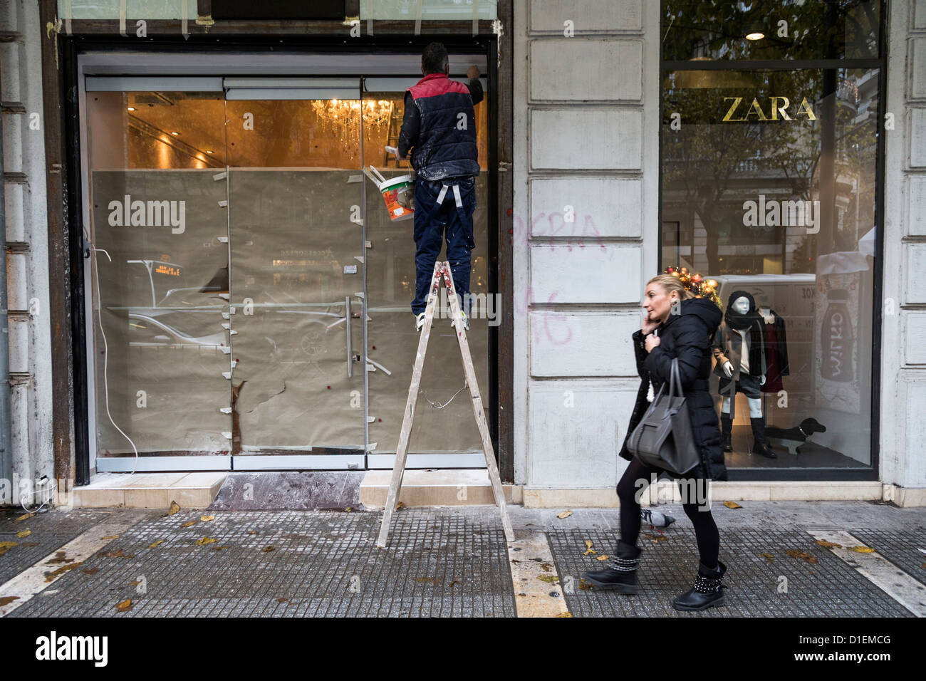 A woman walks past a store under renovation in commercial street in ...
