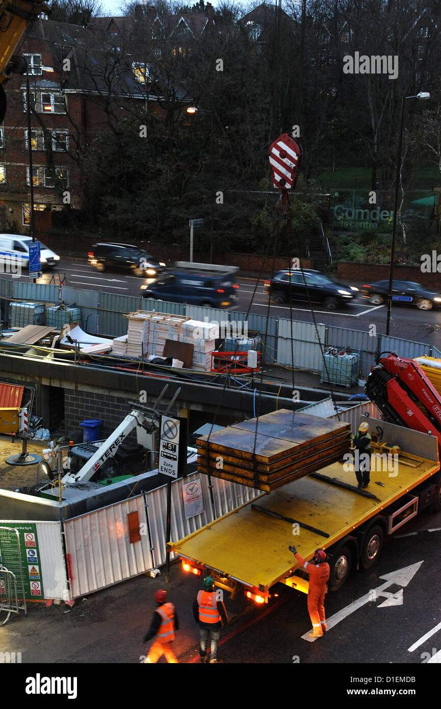 builders load heavy equipment for building site from lorry onto pulley ...