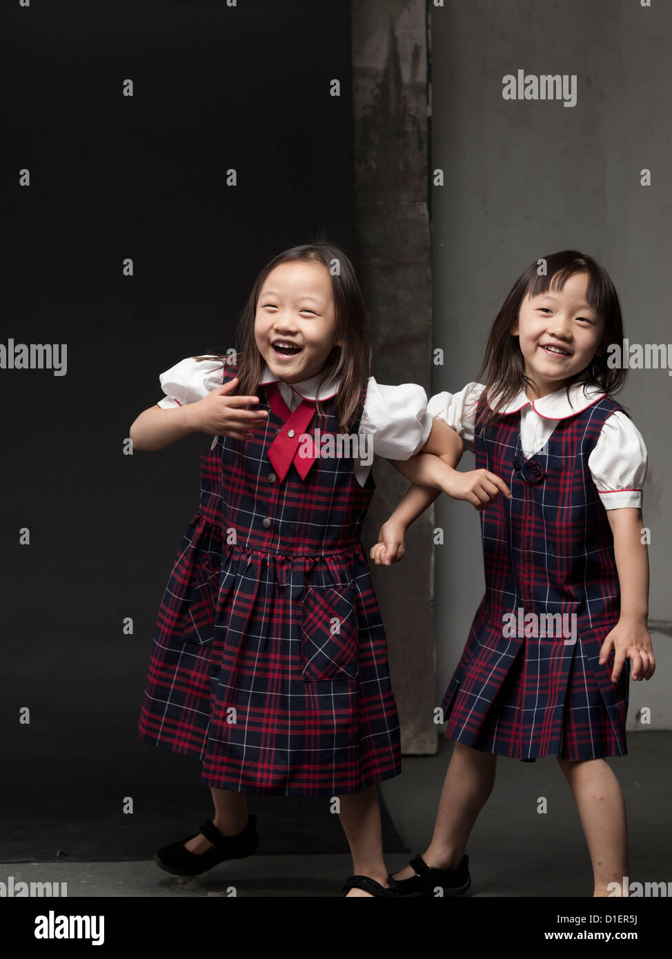 Young Asian twins dancing and performing gymnastics Stock Photo - Alamy