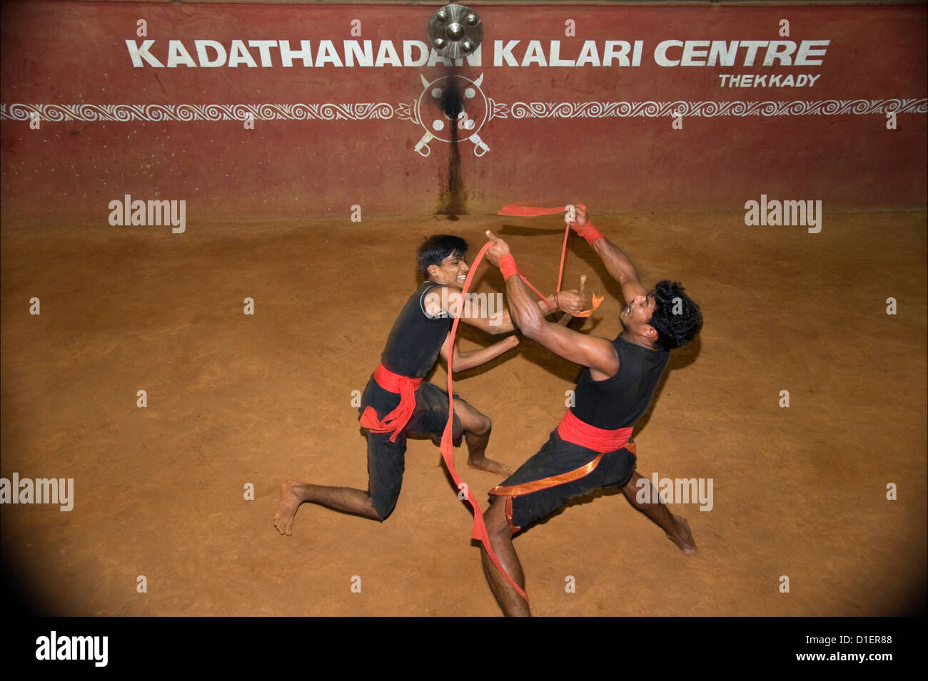 Horizontal portrait of two Kalaripayattu martial artists sparring with ...