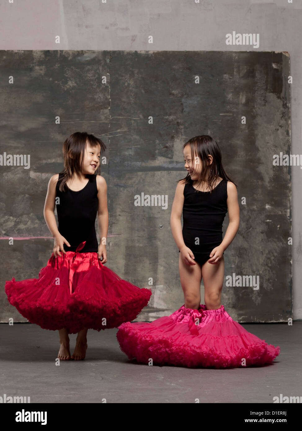 Young Asian twins dancing and performing gymnastics Stock Photo - Alamy