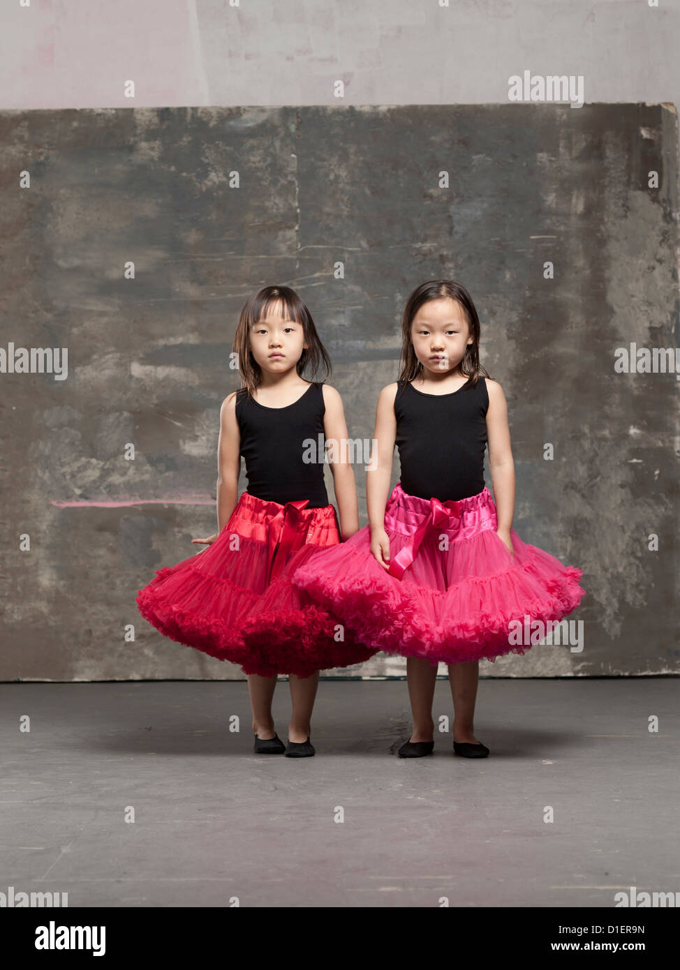 Young Asian twins dancing and performing gymnastics Stock Photo - Alamy