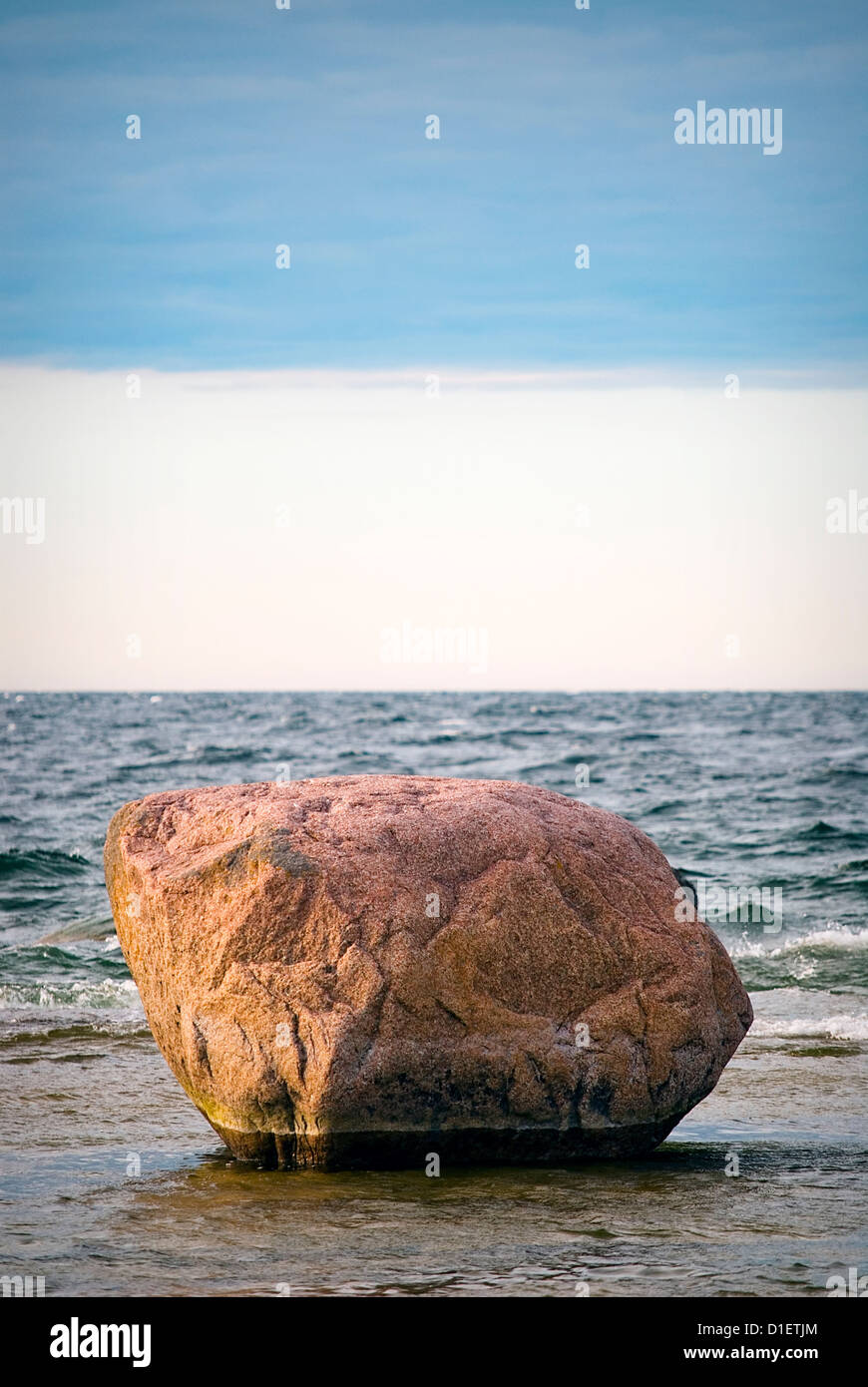 Big rock on beach in evening light, with beautiful sky Stock Photo - Alamy