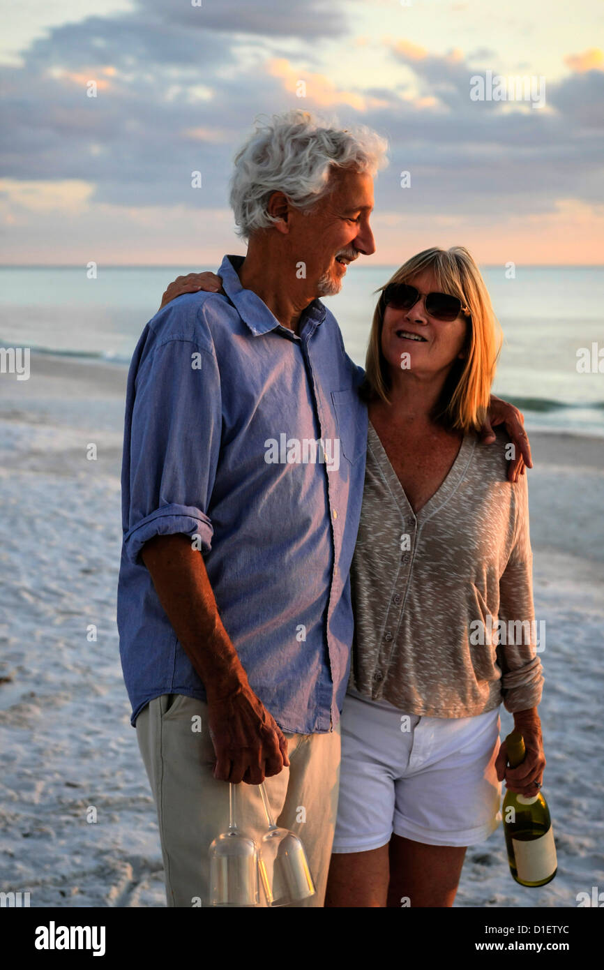 Retired couple enjoy a romantic walk on Siesta Key beach Florida at ...