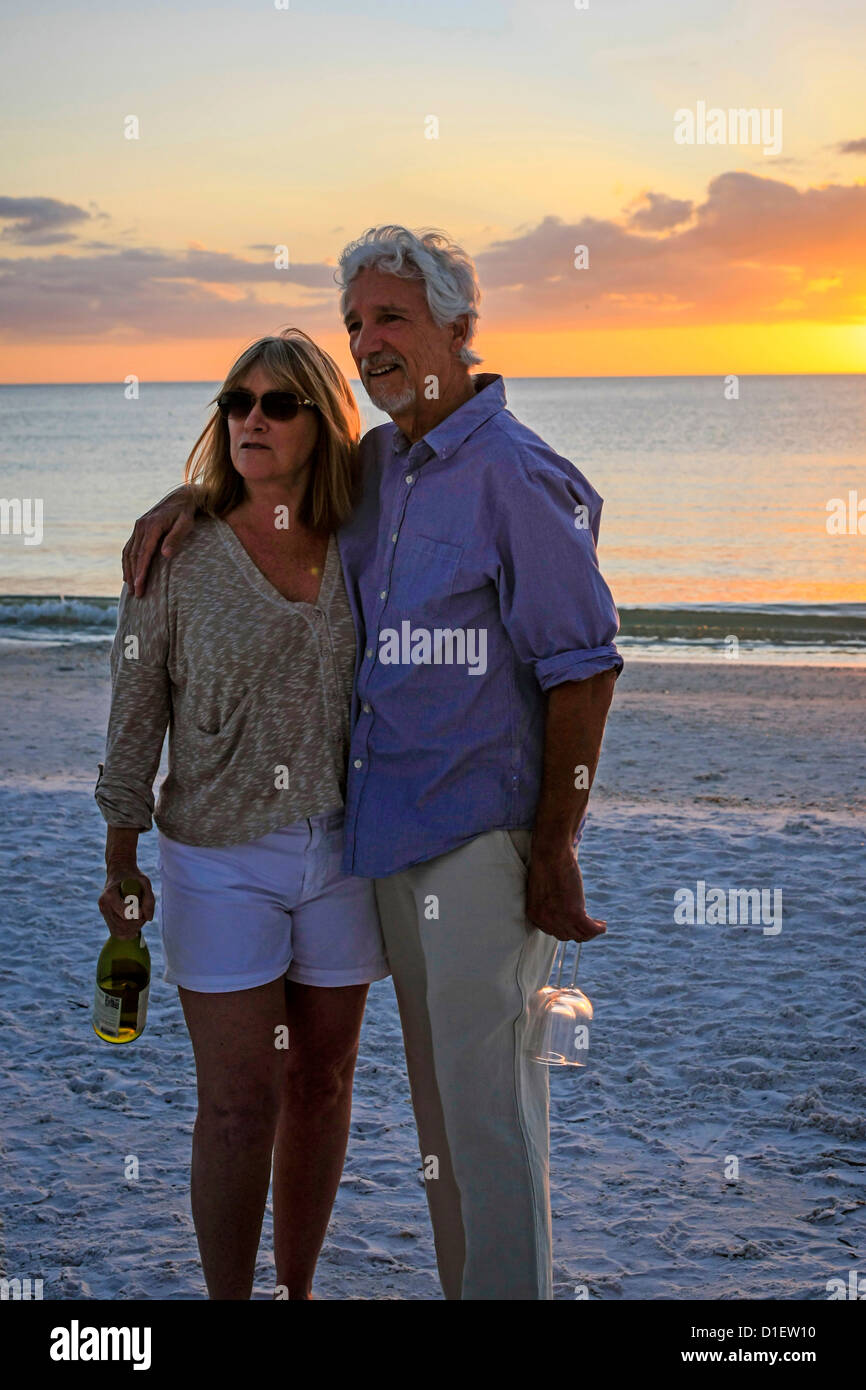 Retired couple enjoy a romantic walk on Siesta Key beach Florida at ...