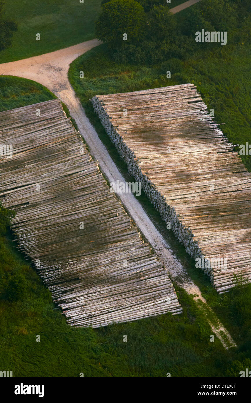 Stacked logs by the roadside, aerial photo Stock Photo - Alamy