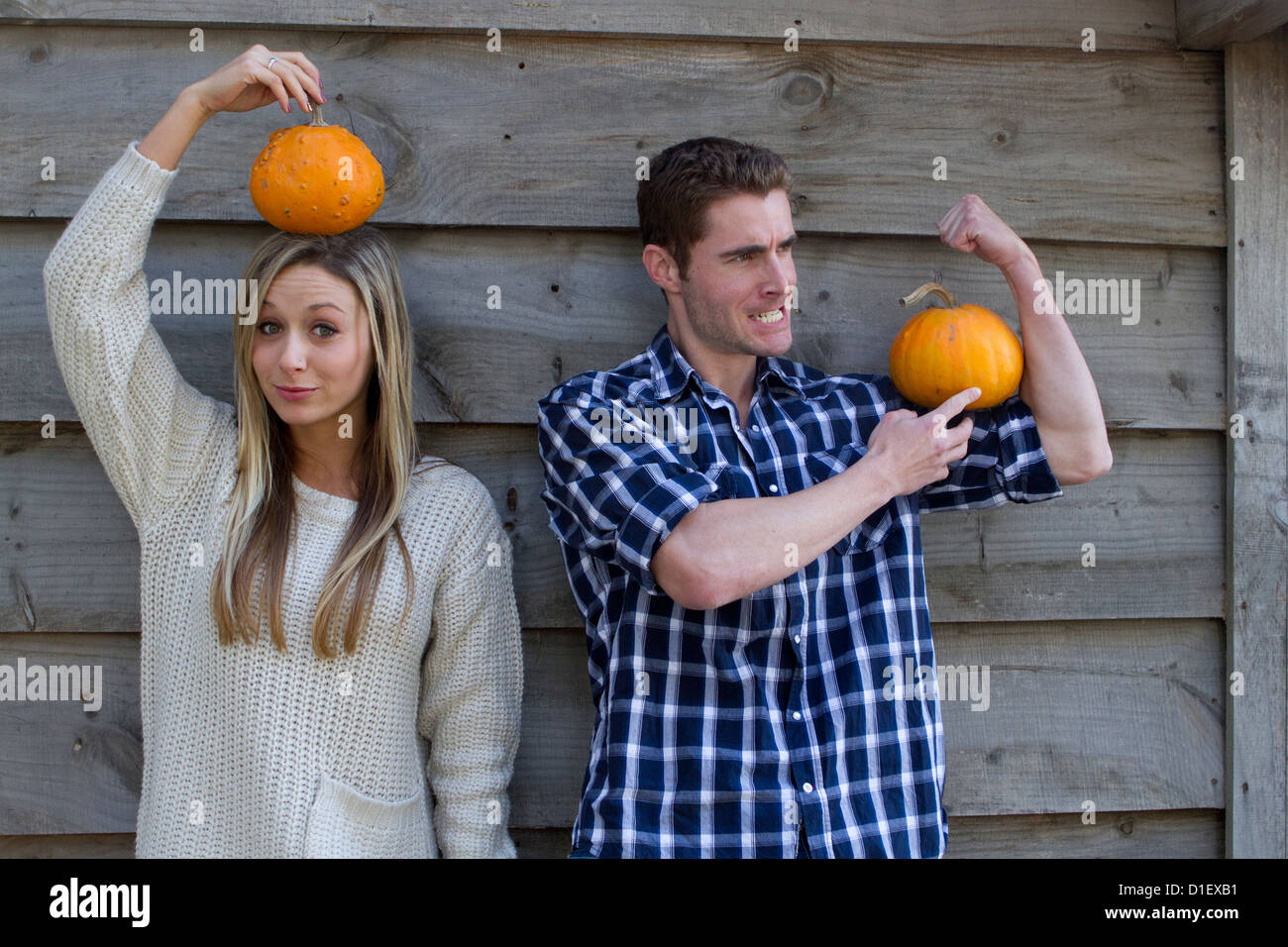 A young couple being playful at an old barn Stock Photo - Alamy