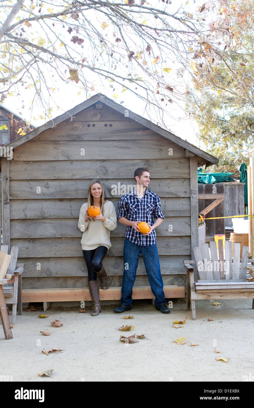 A young couple being playful at an old barn Stock Photo - Alamy