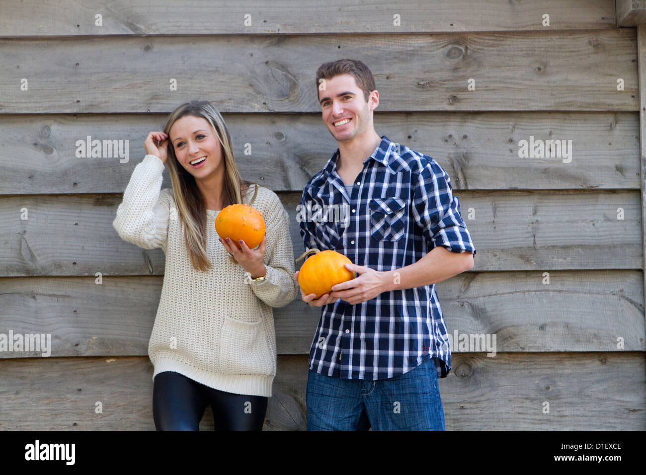 A young couple being playful at an old barn Stock Photo - Alamy
